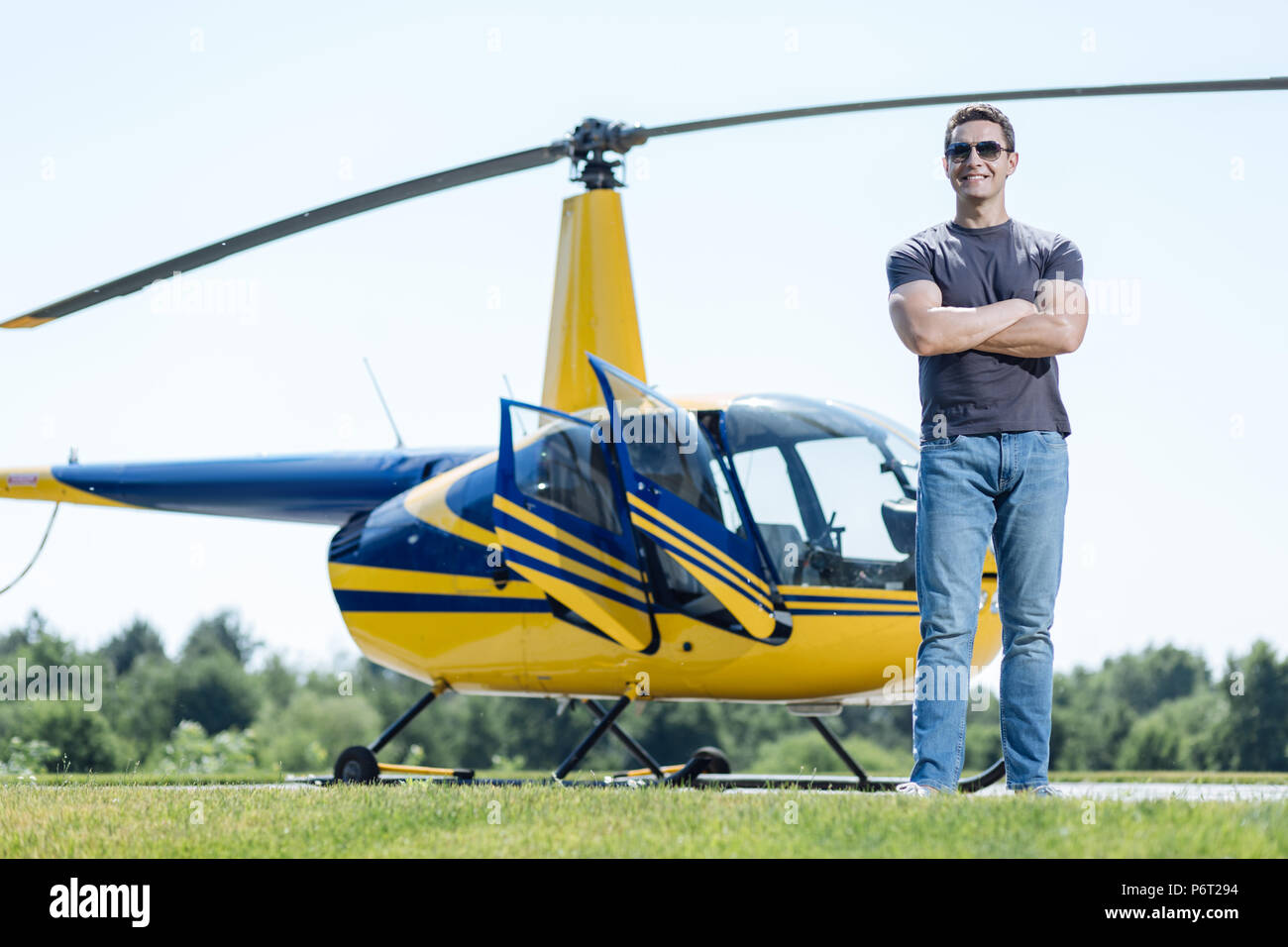 Athletic air policeman posing in front of a helicopter Stock Photo - Alamy