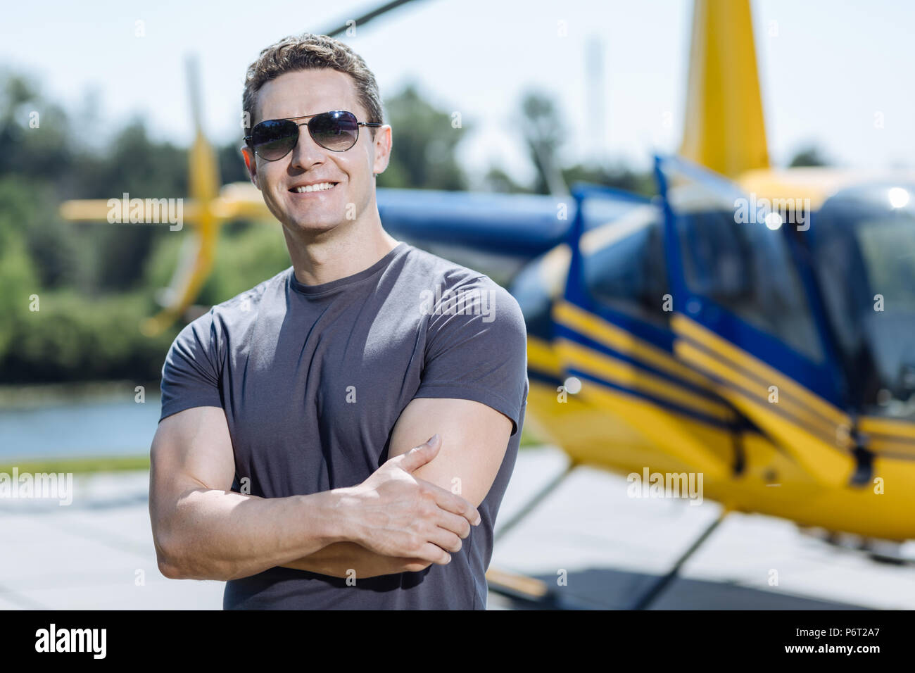 Charming young pilot posing at a helipad Stock Photo - Alamy