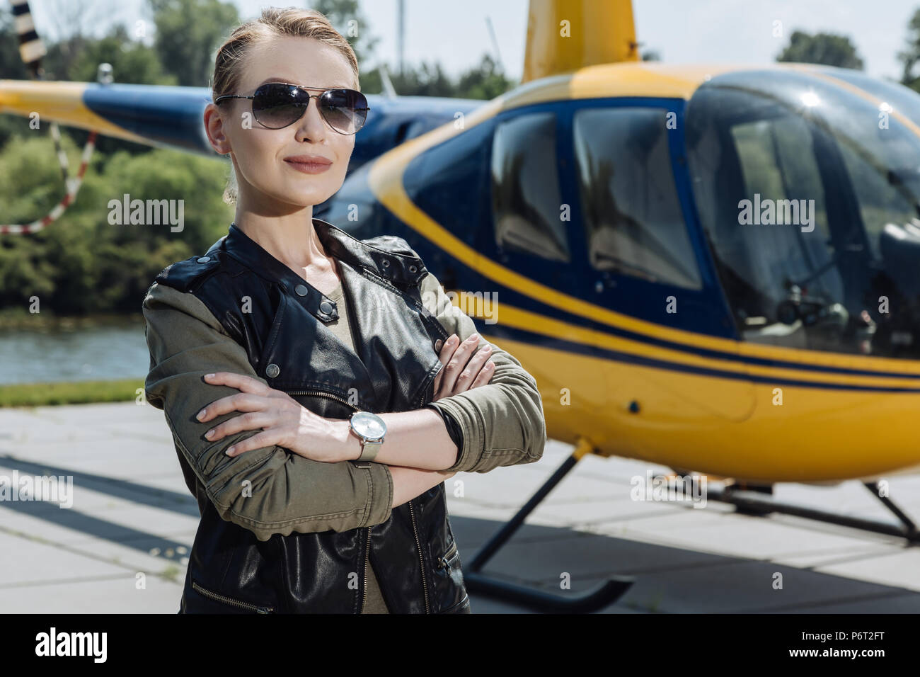 Beautiful female pilot posing at helipad Stock Photo - Alamy