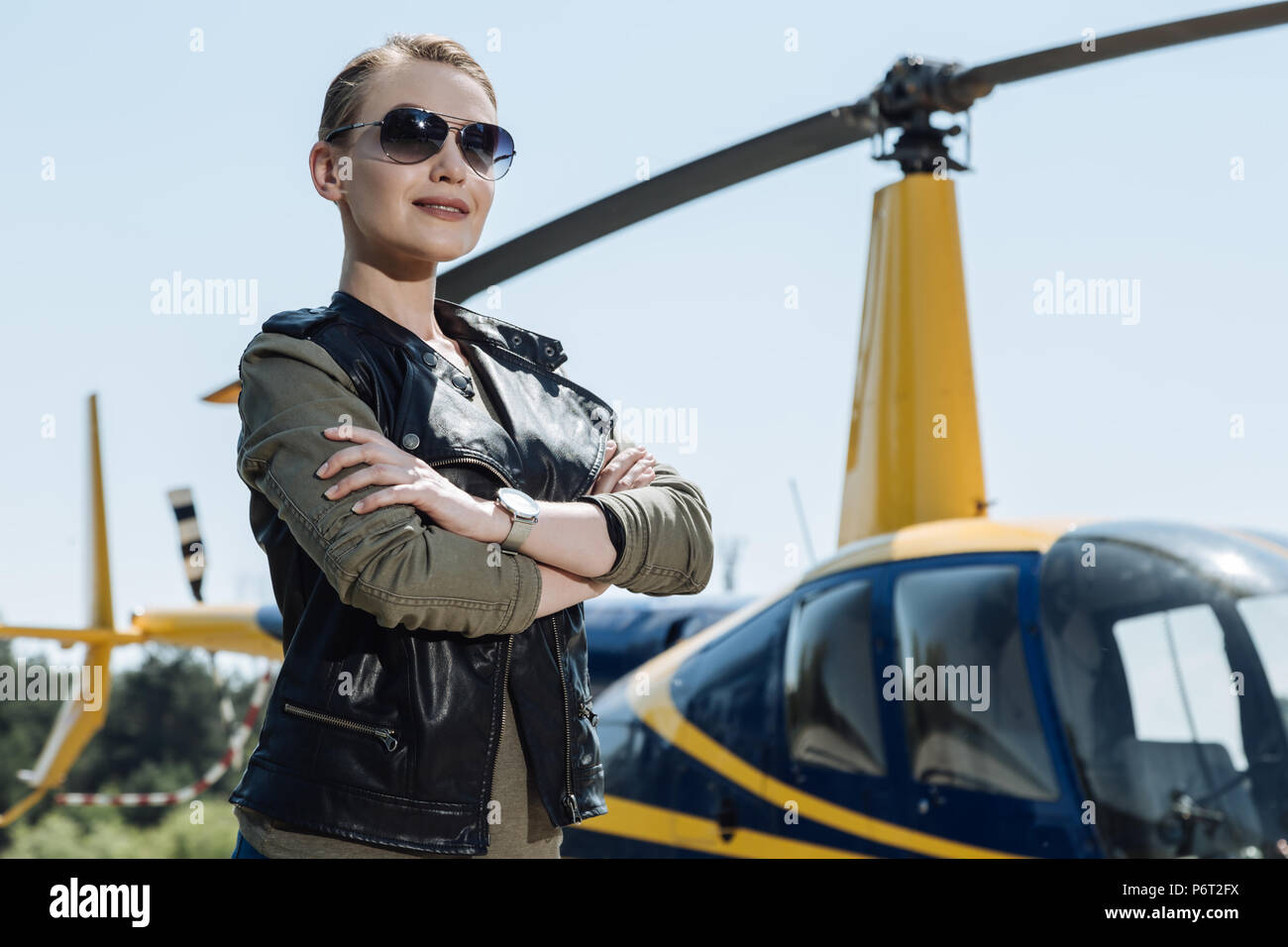 Gorgeous female pilot posing before taking helicopter ride Stock Photo ...