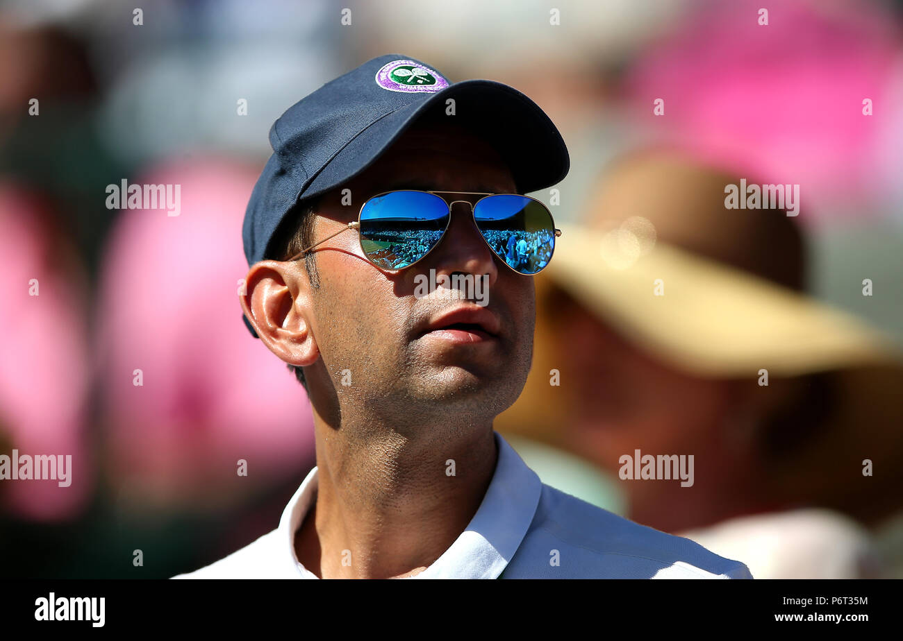 A spectator watches the action of Court one on day One of the Wimbledon ...