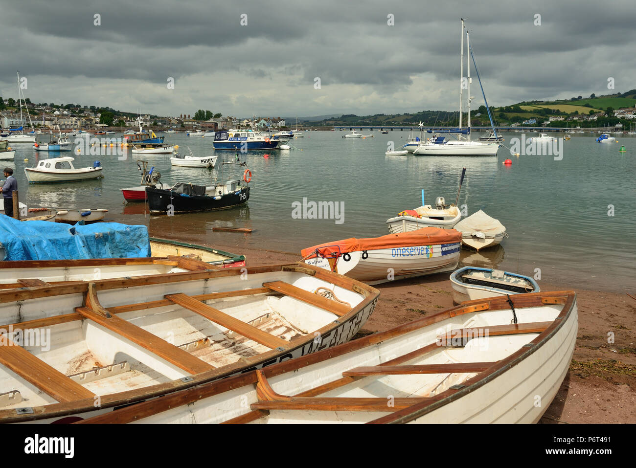 Boats moored in the Teign estuary at Teignmouth. Shaldon bridge is ...