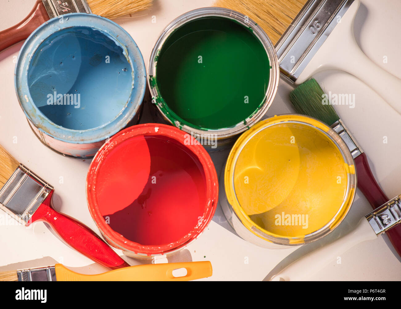 Paint brushes and opened paint cans with colors Stock Photo - Alamy