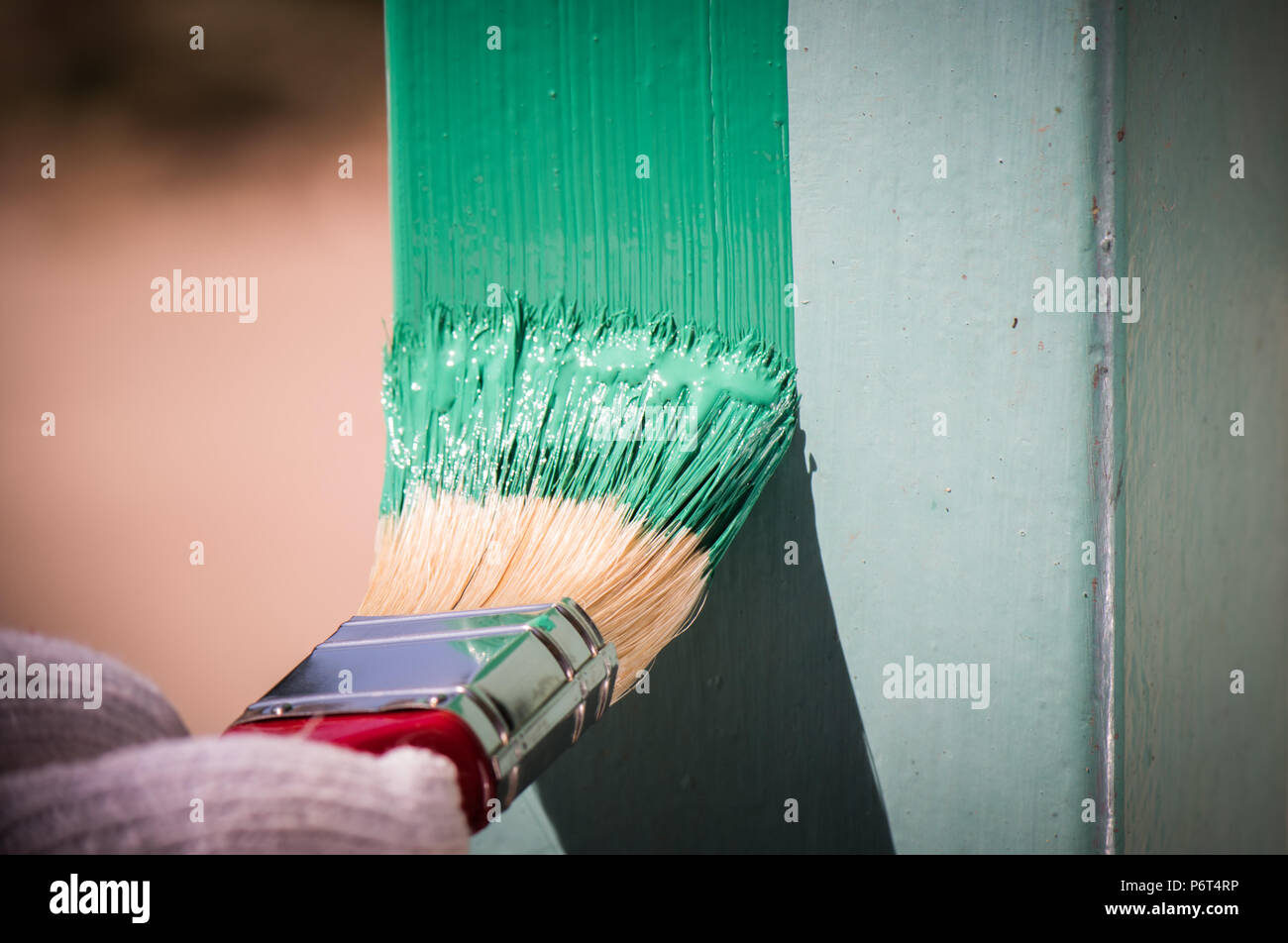 Men is painting metal surface with a brush Stock Photo - Alamy