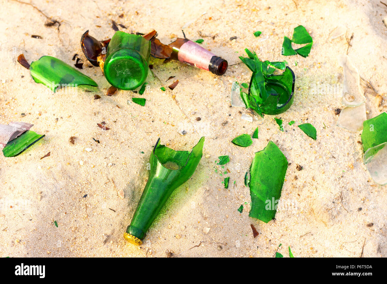 Broken beer glass bottles on a sand Stock Photo - Alamy