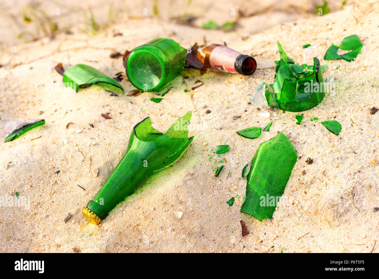 Broken beer glass bottles on a sand Stock Photo - Alamy