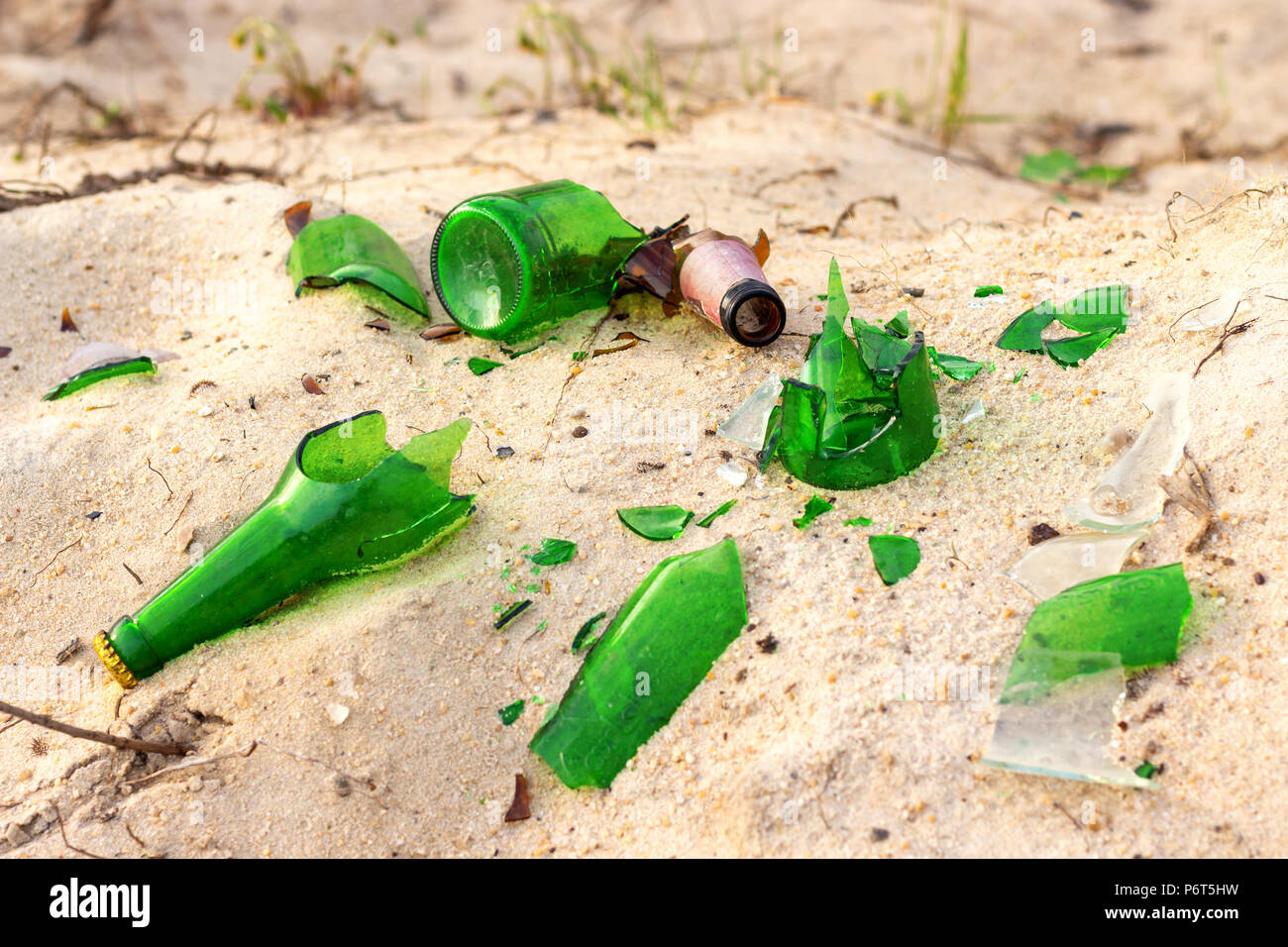 Broken beer glass bottles on a sand Stock Photo - Alamy