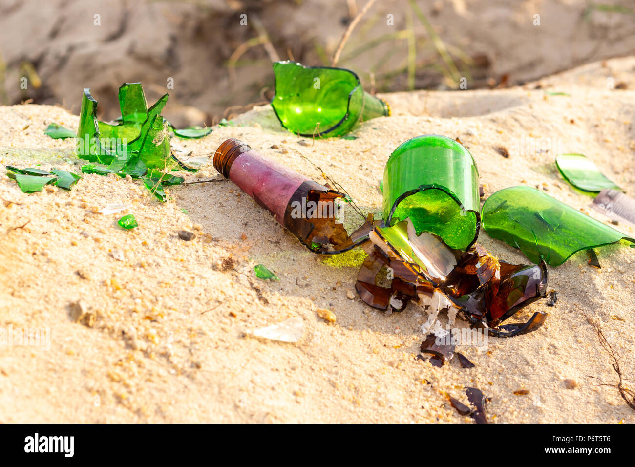 Broken beer glass bottles on a sand Stock Photo - Alamy