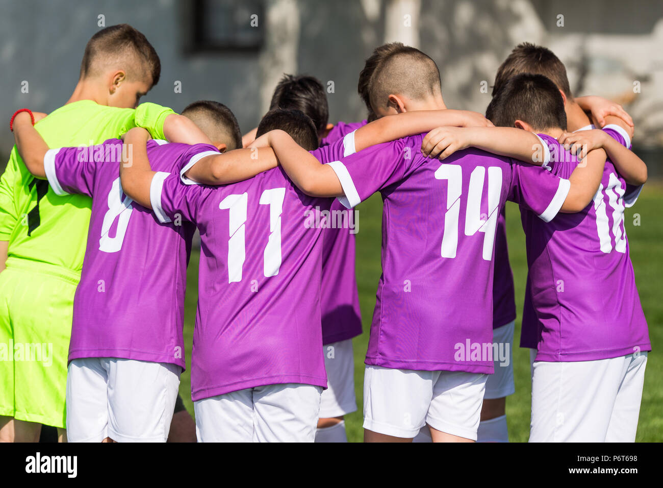 Kids soccer football - young children players celebrating in hug after ...