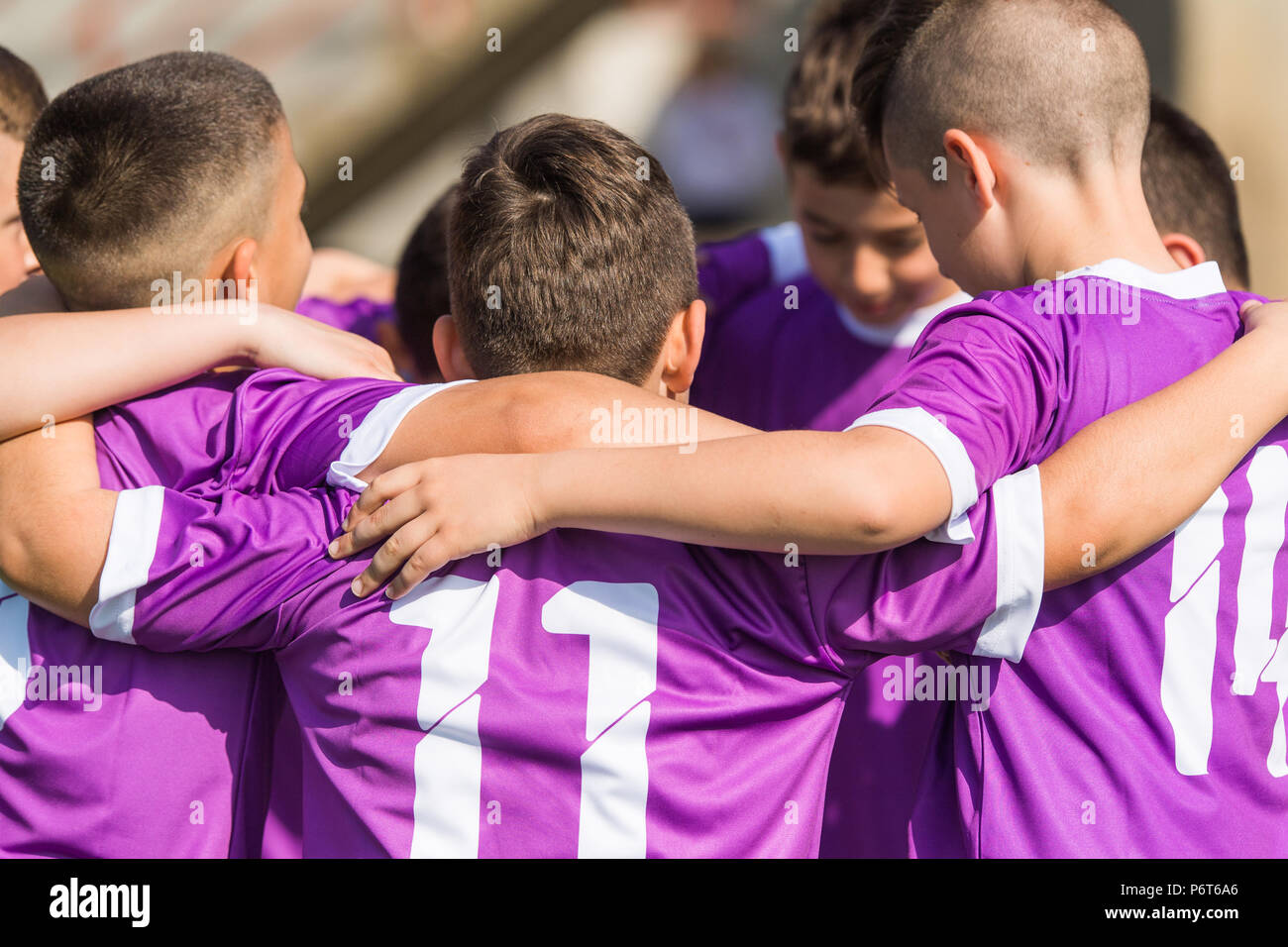 Kids soccer football - young children players celebrating in hug after ...