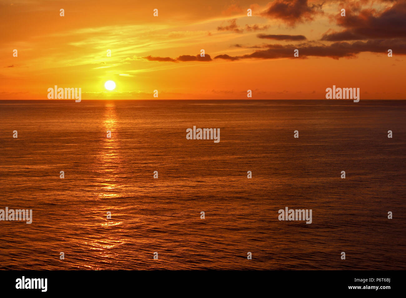 A boat on a still ocean at sun set hi-res stock photography and images ...