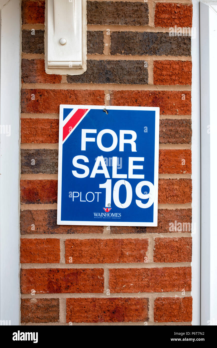 For Sale sign on the wall of a newly constructed house Stock Photo - Alamy