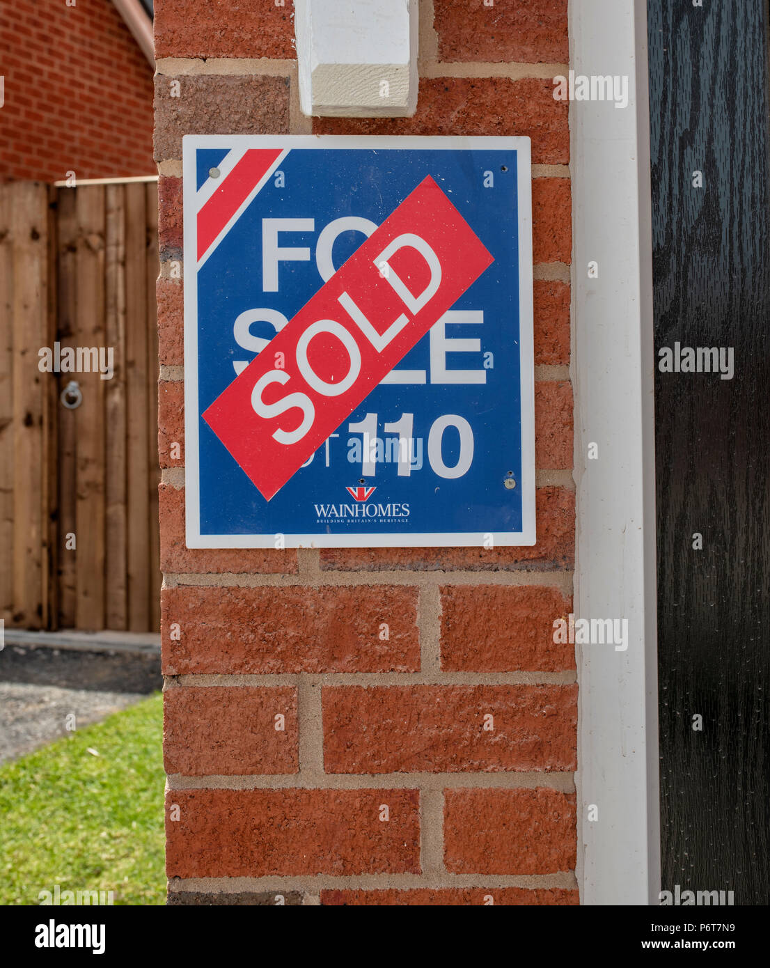 Sold sign on the wall of a newly constructed house Stock Photo - Alamy