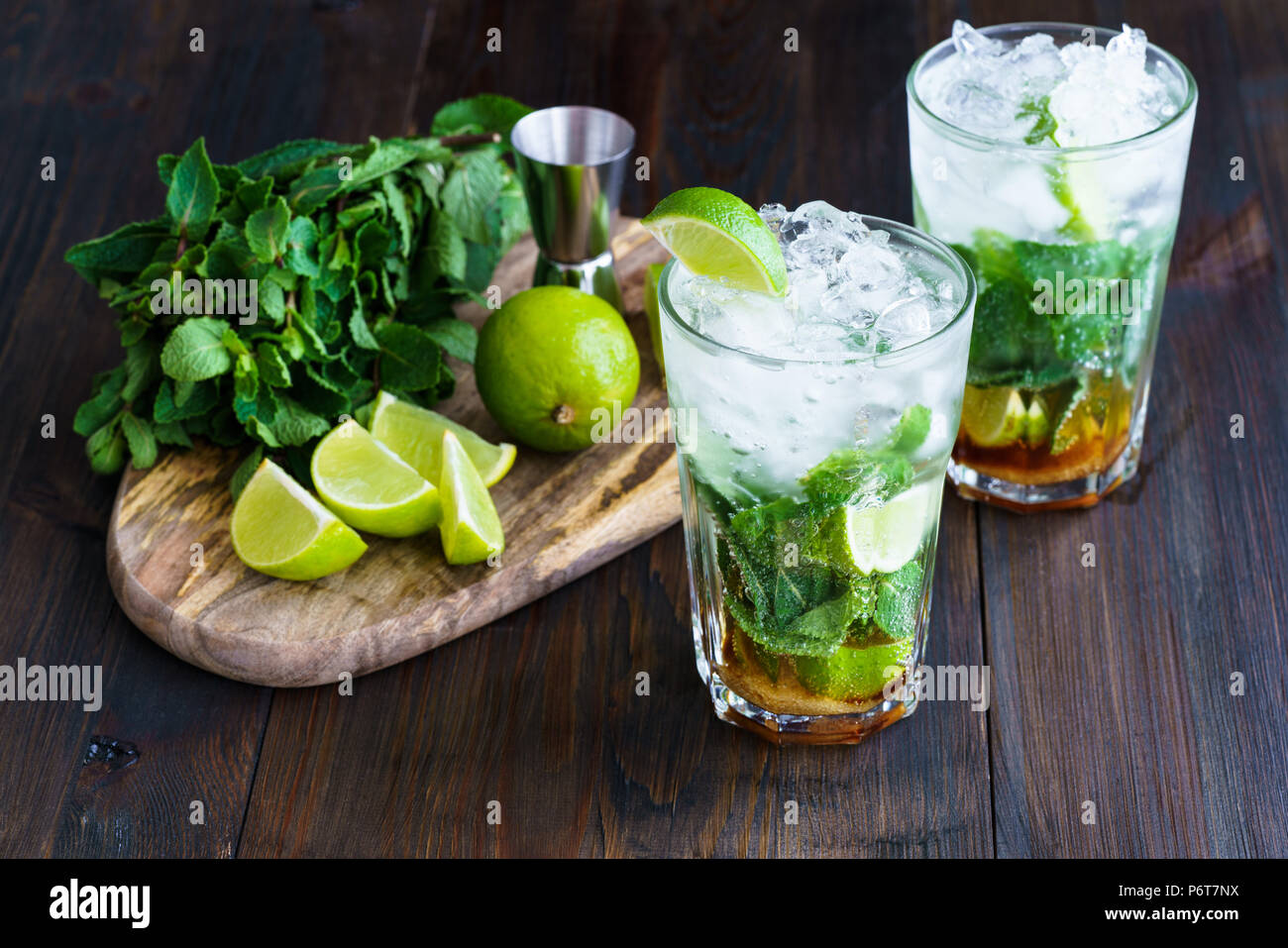 Dirty mojito and ingredients (fresh mint, sliced lime) served on a dark ...
