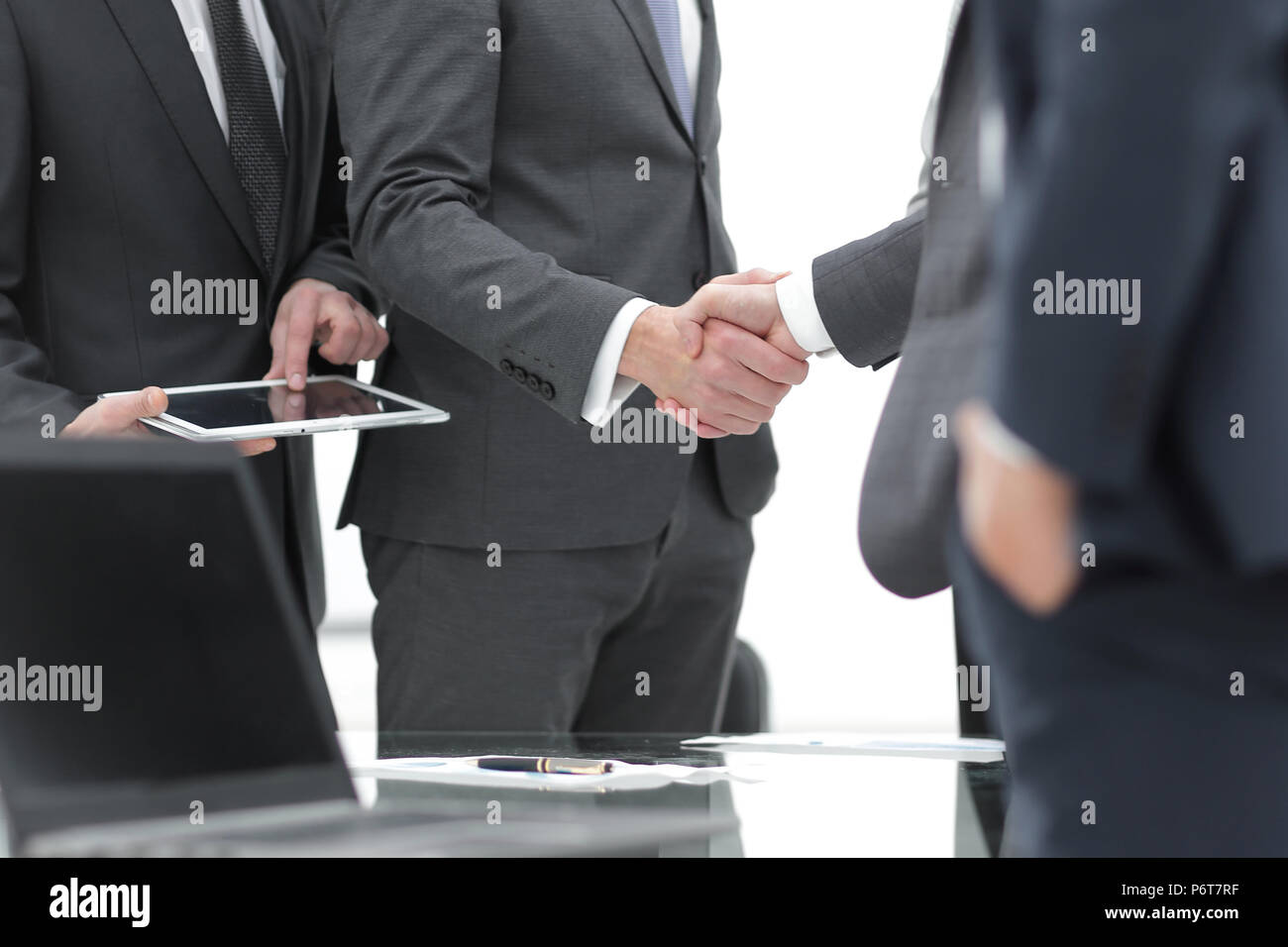 Business partners handshaking with their colleagues Stock Photo - Alamy