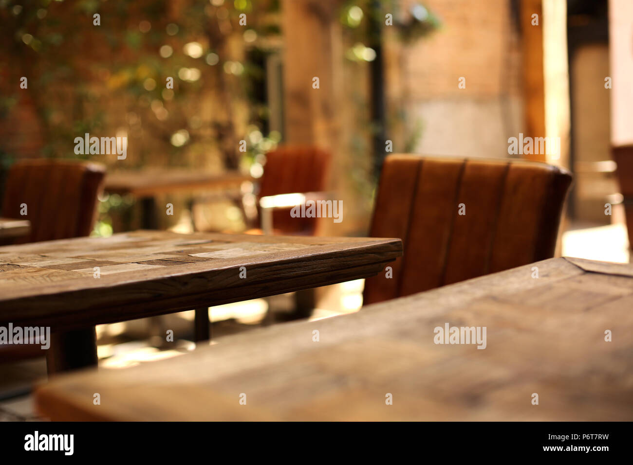 Wooden table in focus and blurred background of cozy cafe Stock Photo ...