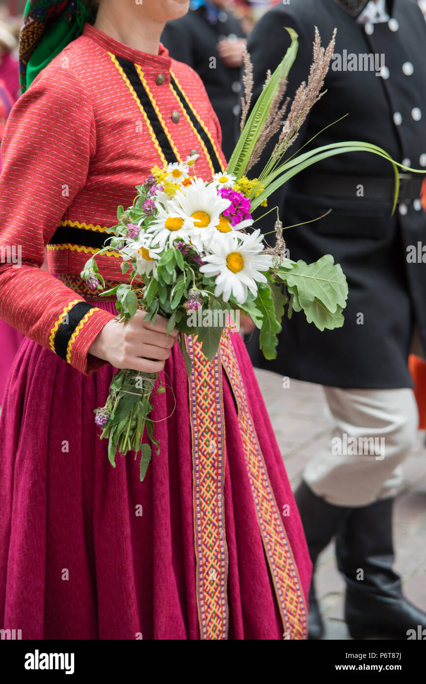 National latvian elements and suits, people with bouquets of field ...