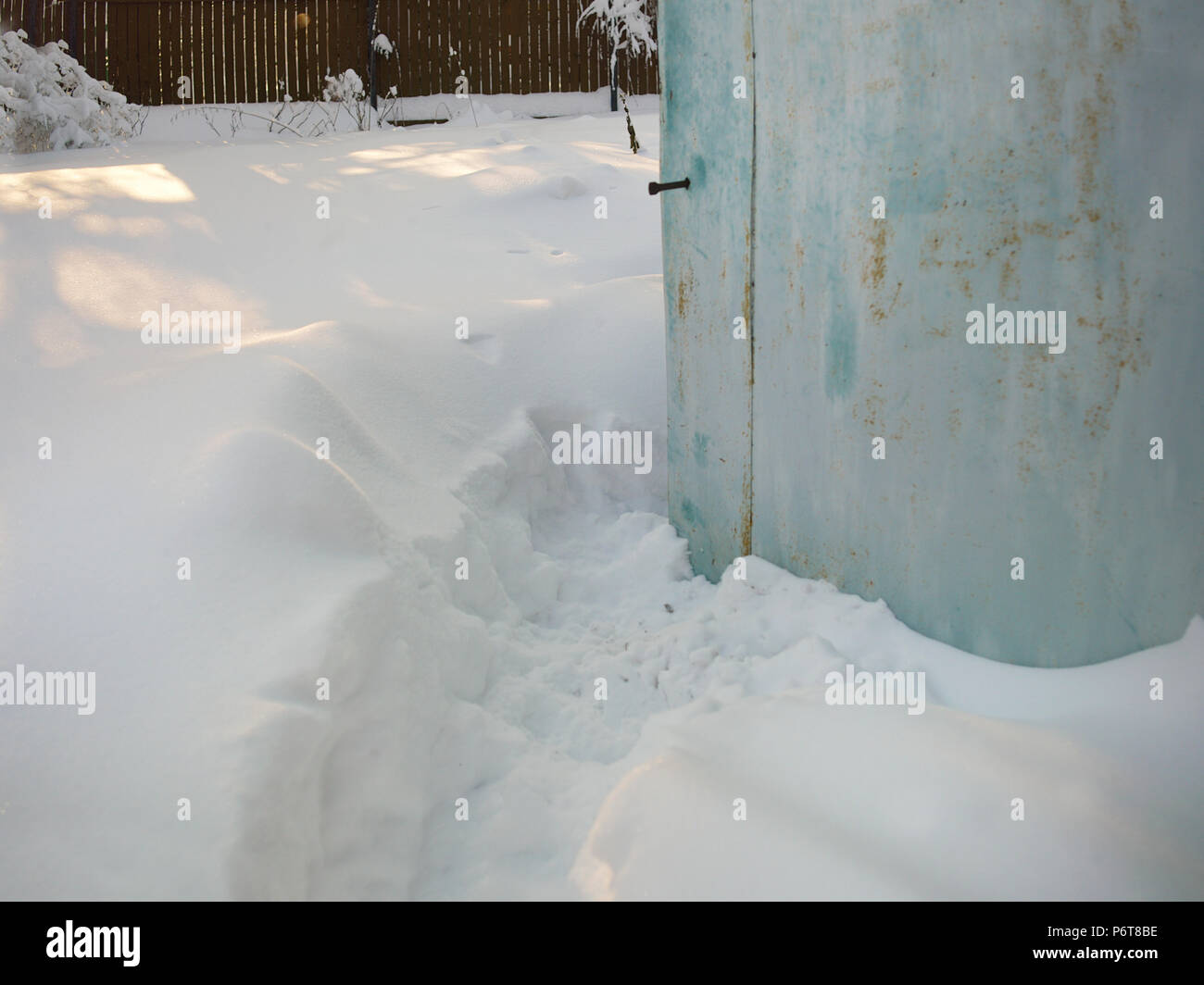 A metal door stuck in the snow pile, winter daytime scene Stock Photo ...