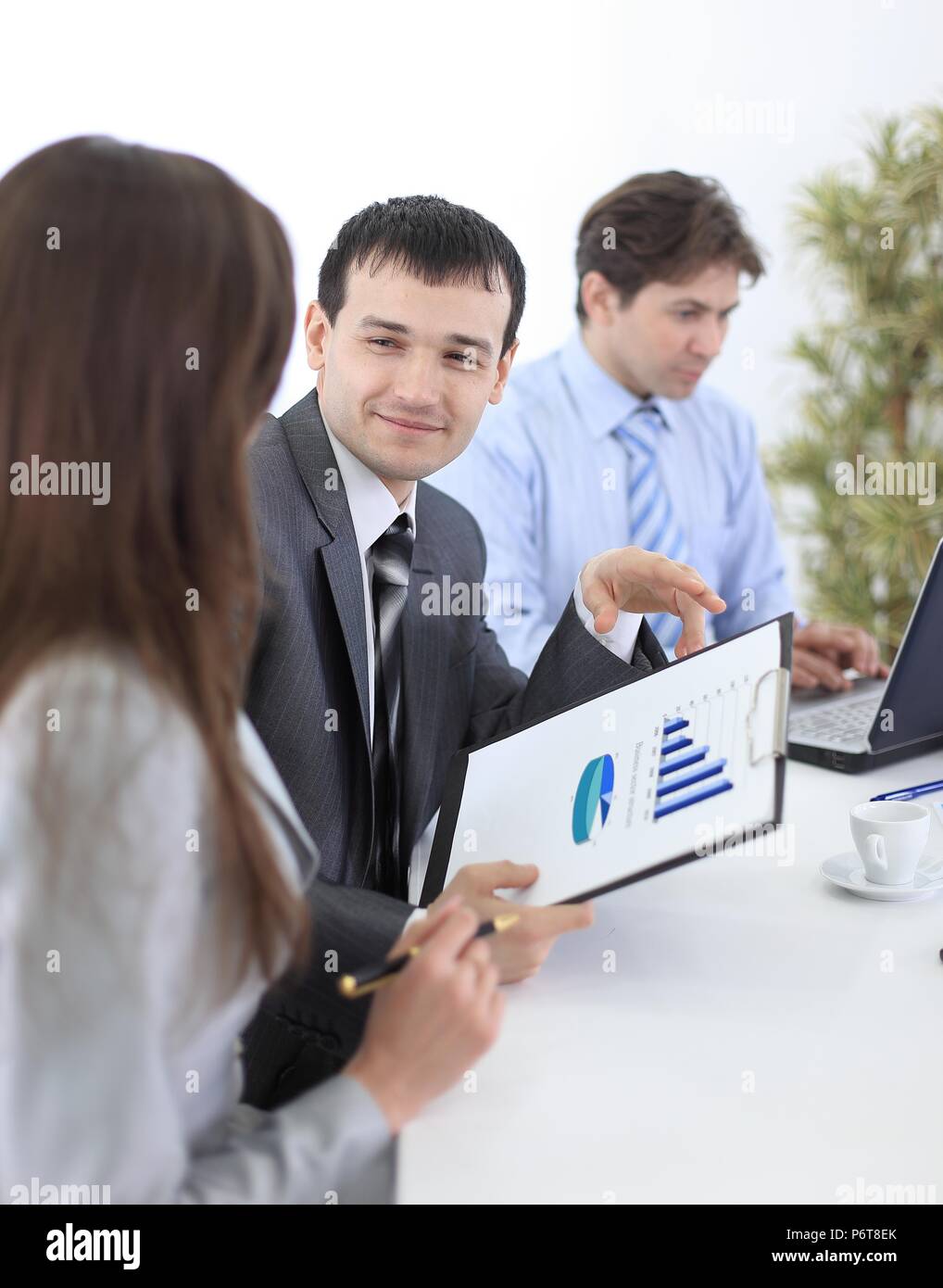 Manager and colleagues in the workplace Stock Photo - Alamy