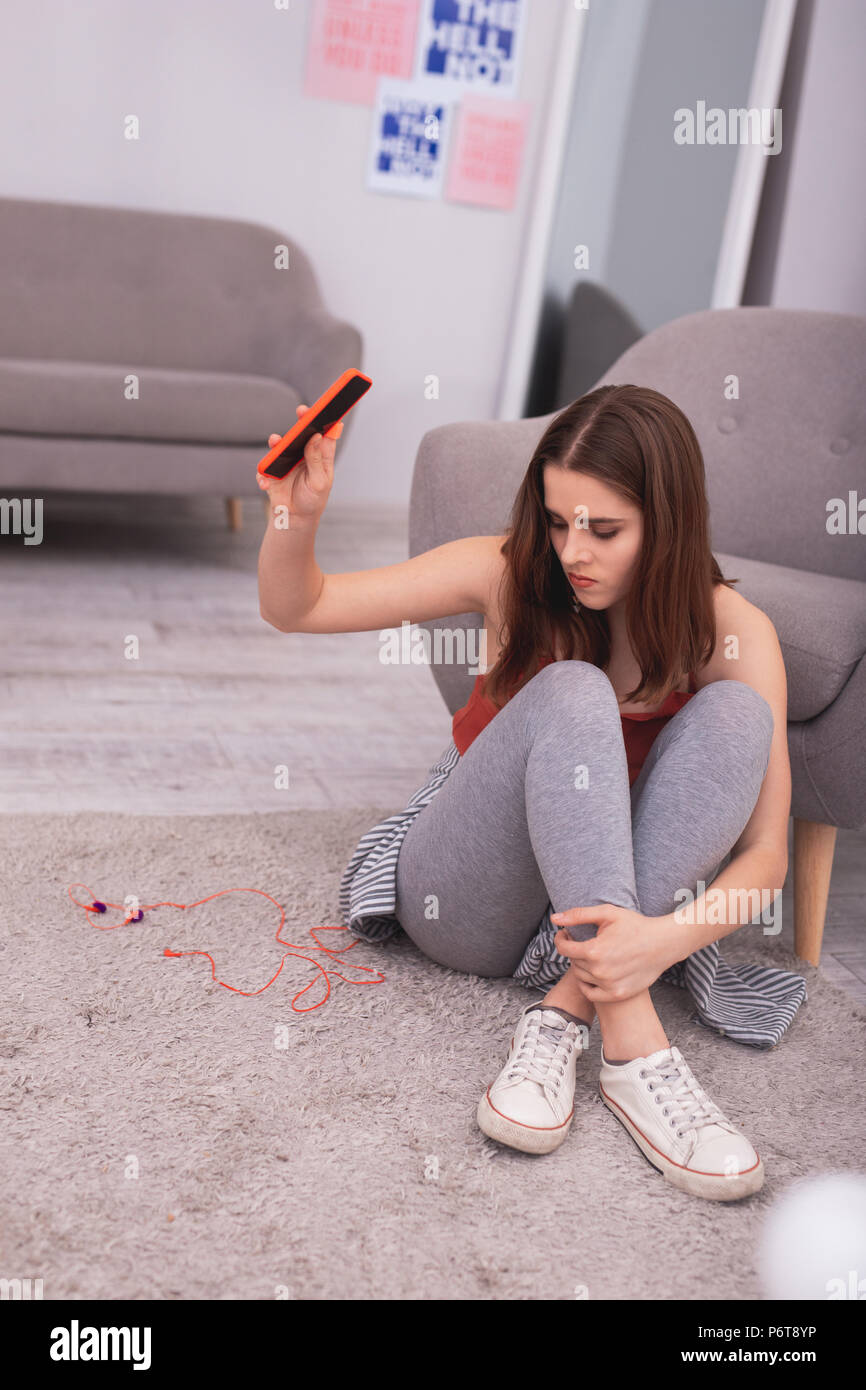 Angry teen girl crashing phone Stock Photo - Alamy