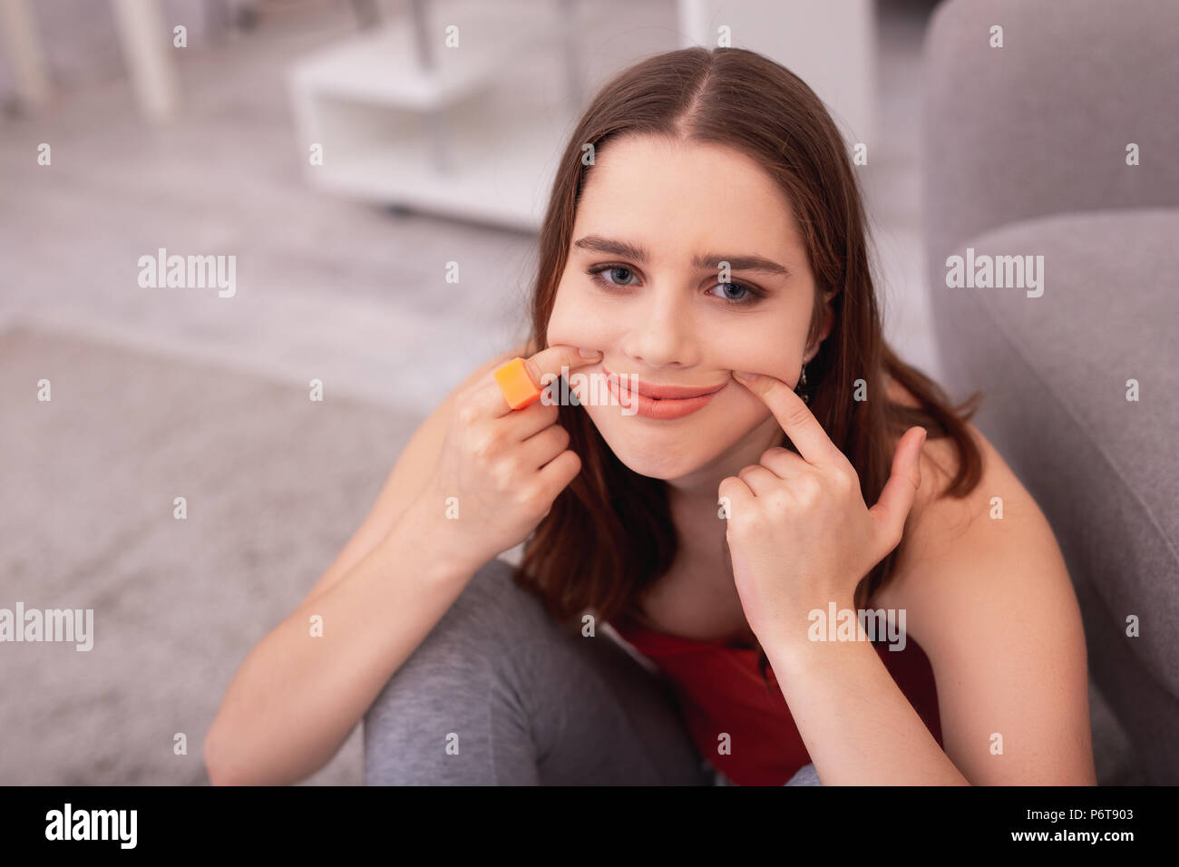 Sad teen girl making smile Stock Photo - Alamy