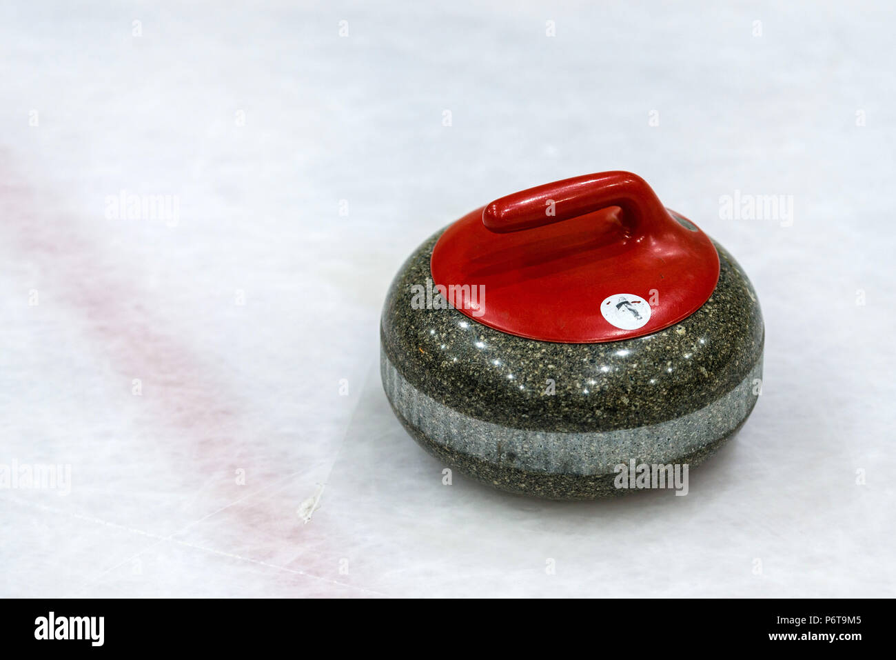 Granite stones for curling game on the ice Stock Photo - Alamy