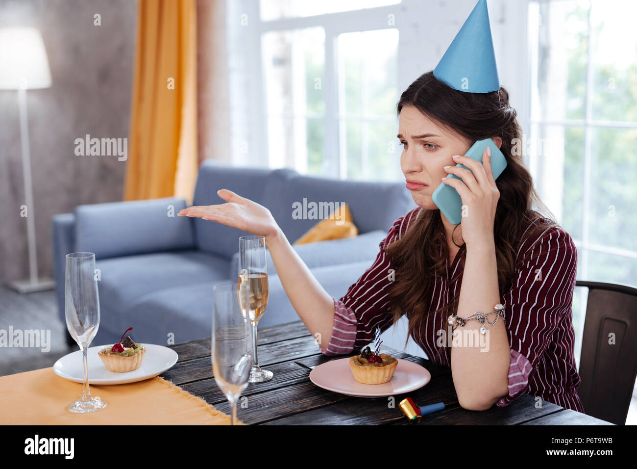 Birthday woman feeling angry hearing stupid excuses Stock Photo - Alamy