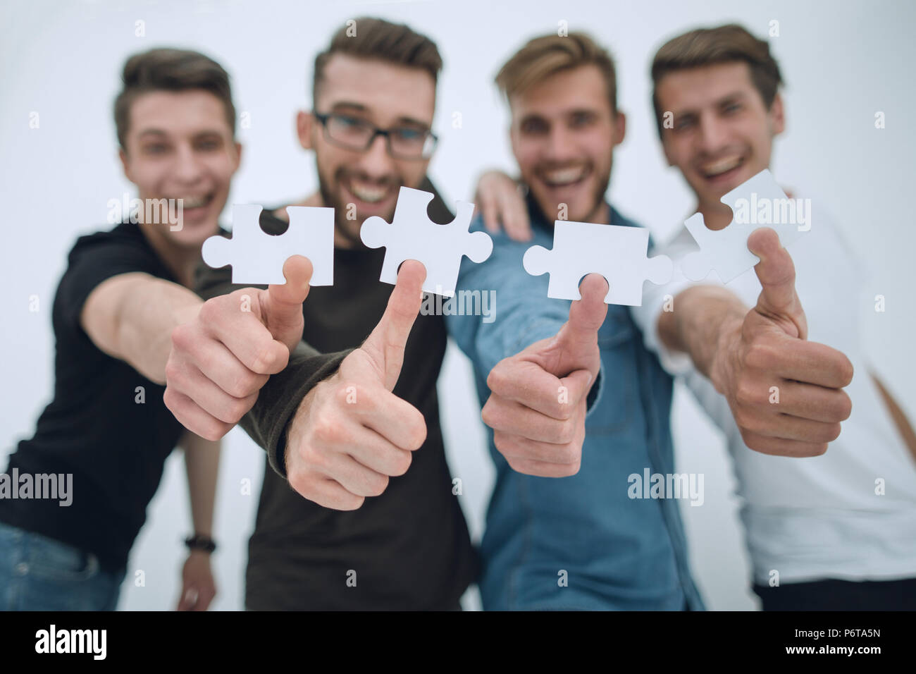 group of young people with puzzle pieces Stock Photo - Alamy