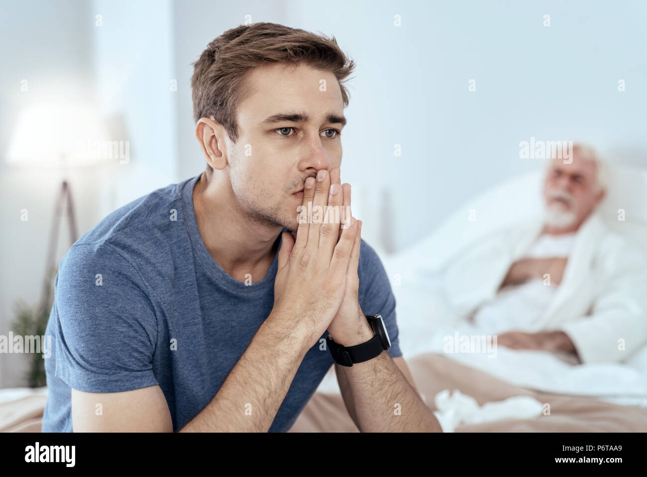 Nervous man flustering about grandpa Stock Photo - Alamy