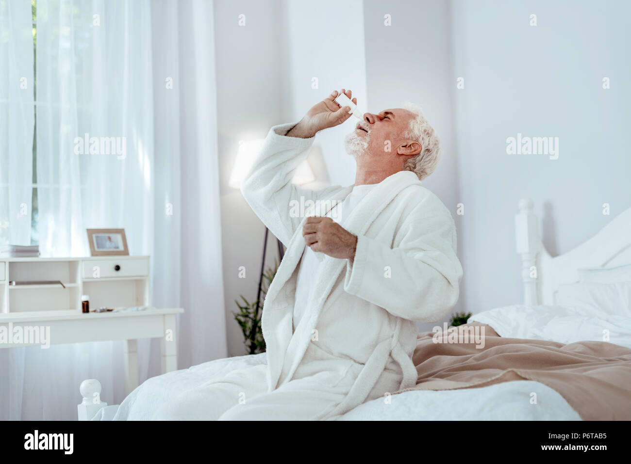 Ill senior man curing illness Stock Photo - Alamy