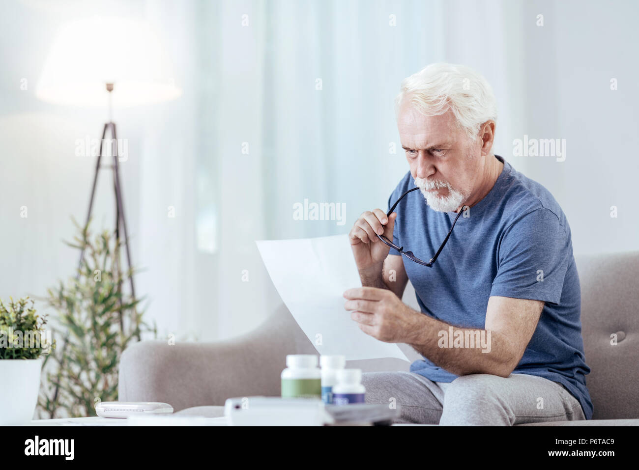 Concentrated senior man reviewing instruction Stock Photo - Alamy