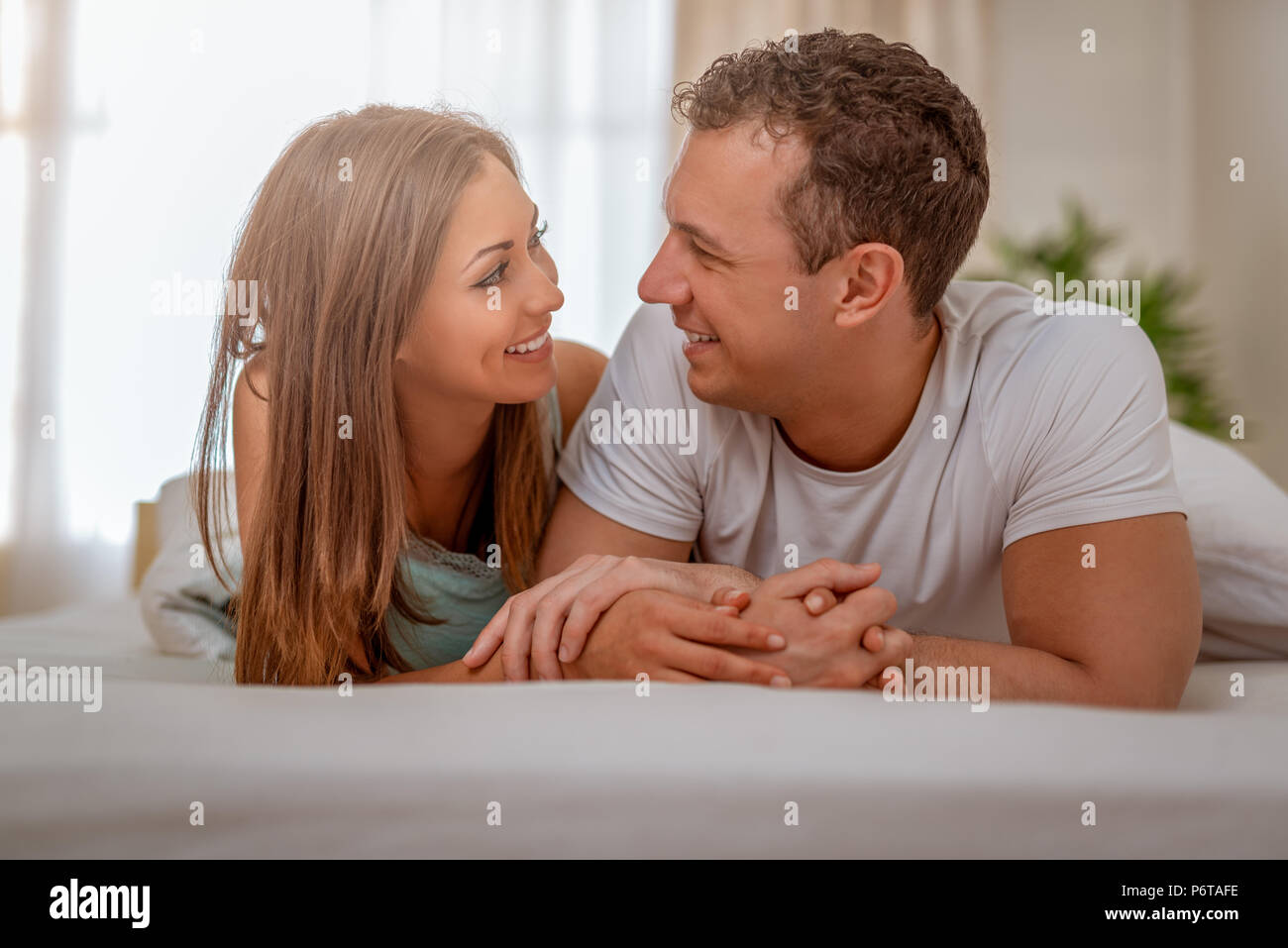 Beautiful young loving couple looking each other with love and having ...