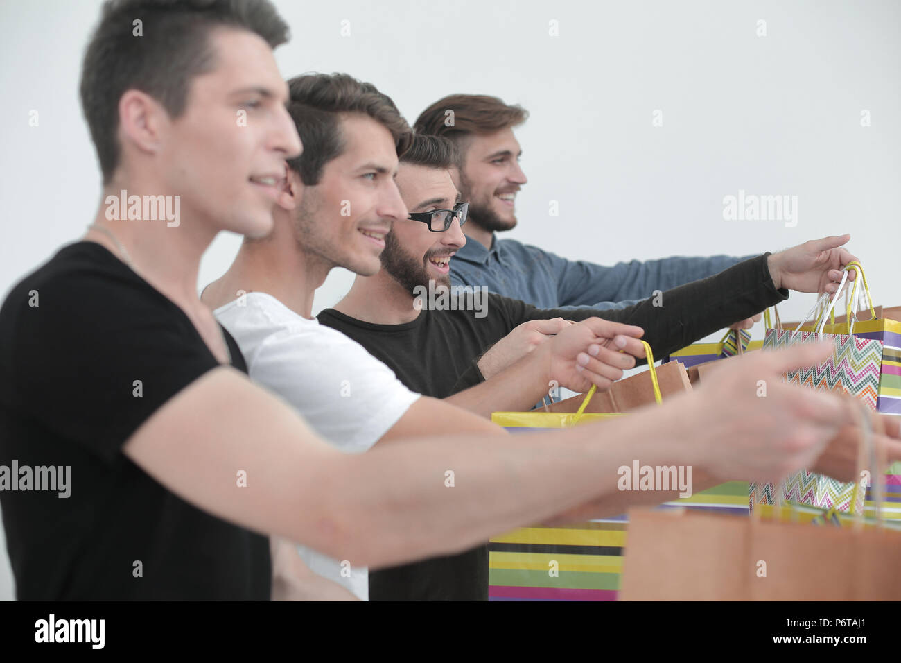 group of young men with shopping bags Stock Photo - Alamy