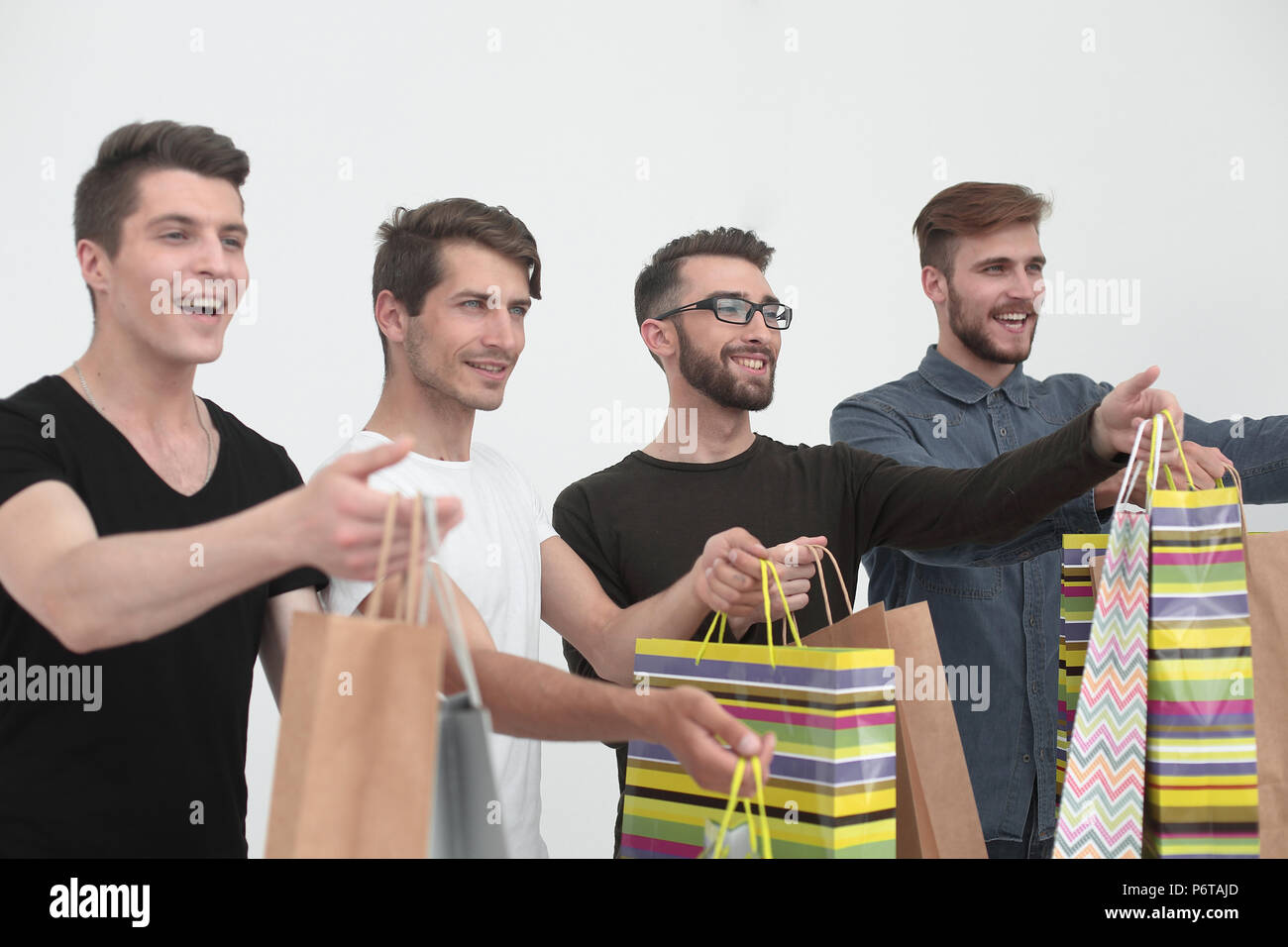 group of young men with shopping bags Stock Photo - Alamy