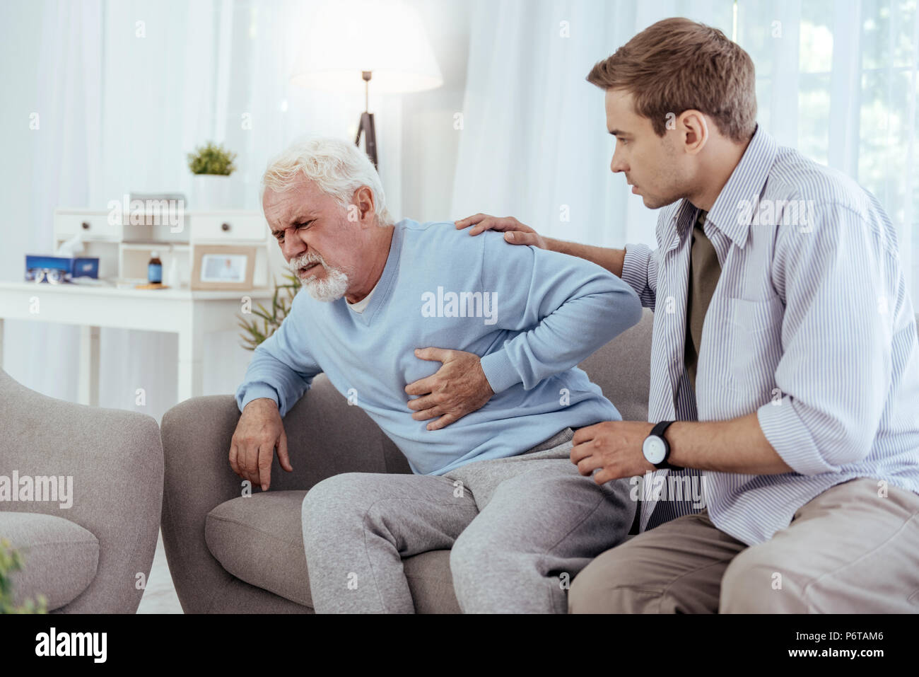 Confident man saving senior man Stock Photo - Alamy