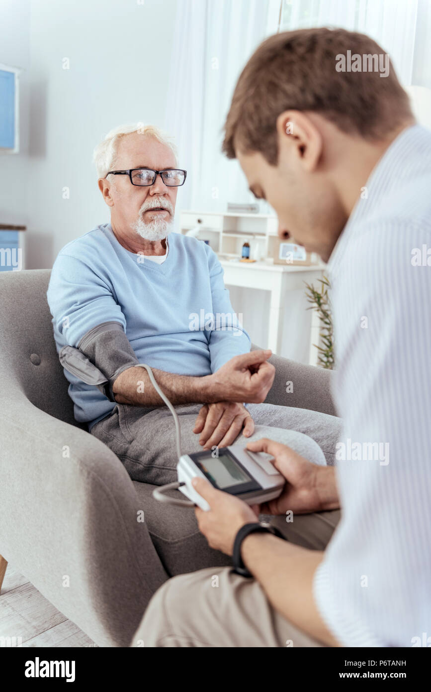 Earnest man defining blood pressure Stock Photo - Alamy