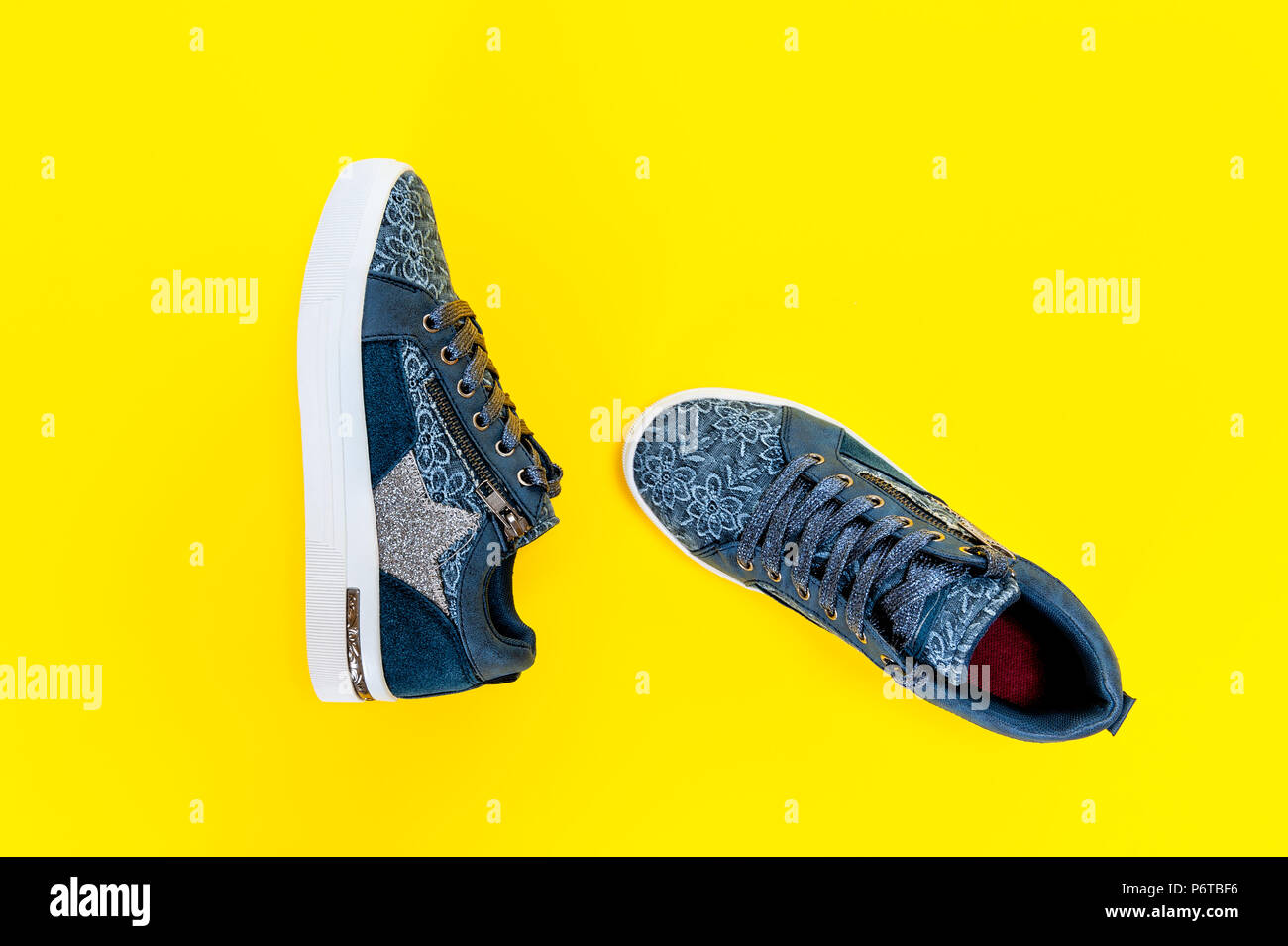 Top view of girl's shoes for leisure photographed on yellow background ...