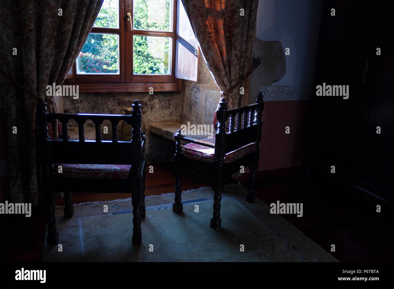 rustic chairs in front of a window Stock Photo - Alamy