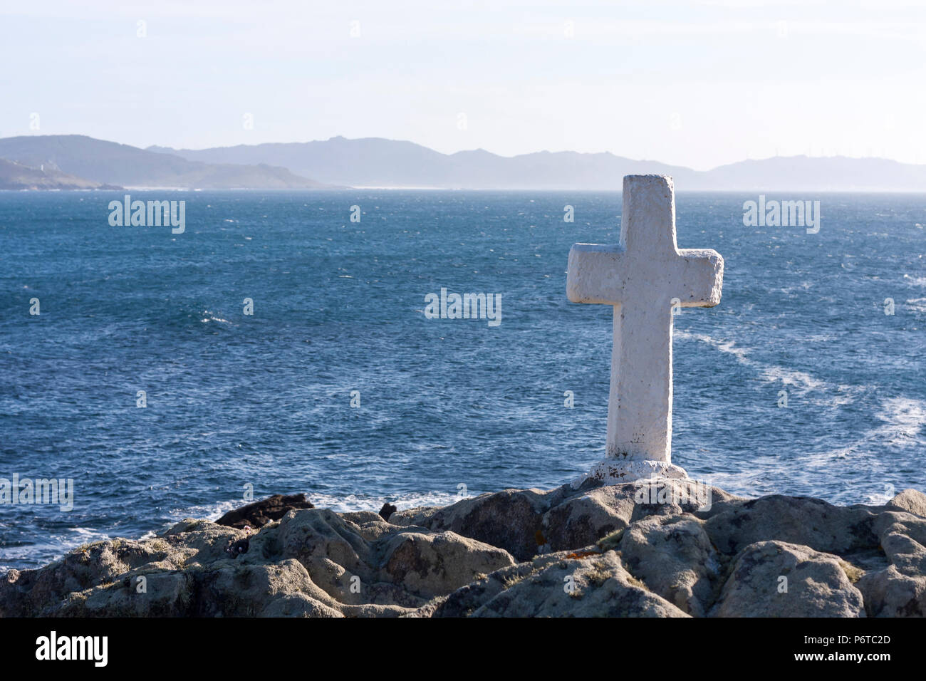 Christian cross on rocks sea hi-res stock photography and images - Alamy