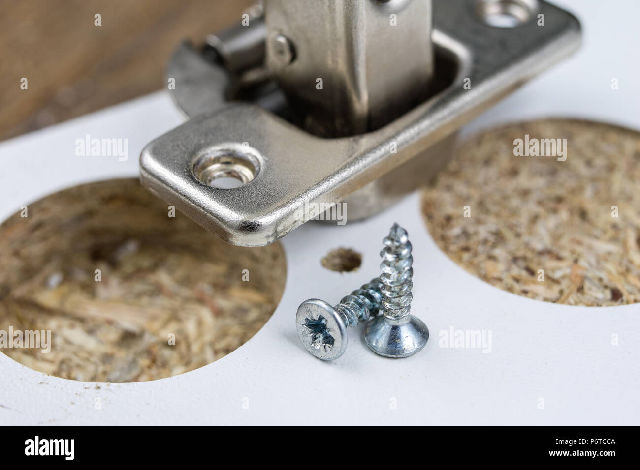 Mounting hinges for chipboard furniture. Joinery accessories used when ...