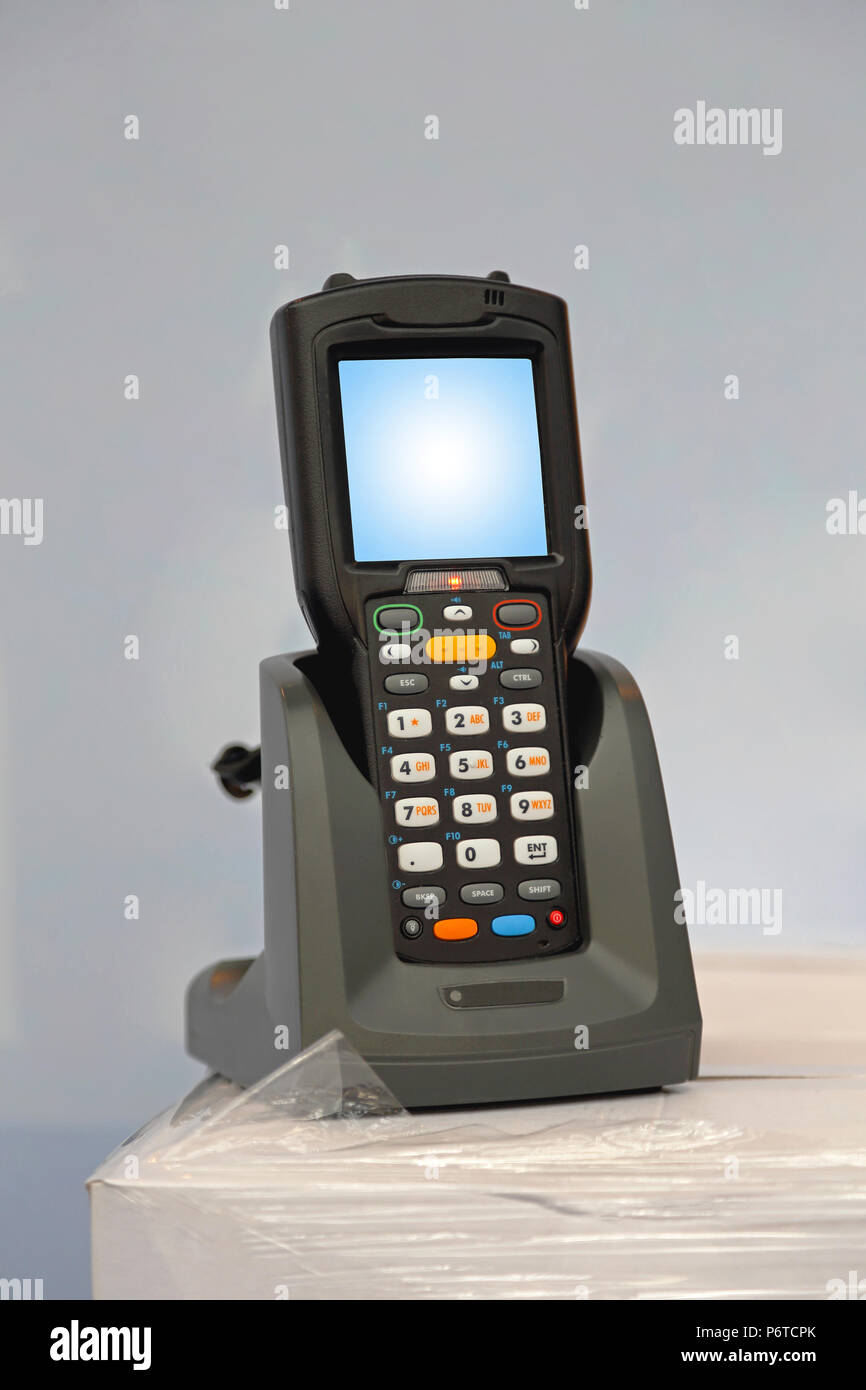 Handheld laser barcode scanner reader at charger dock Stock Photo - Alamy