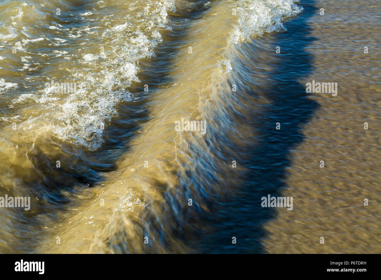 Pattern formed by water rushing back to the ocean as a wave recedes, on ...