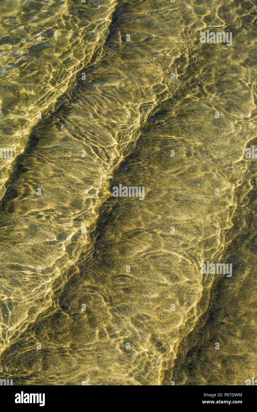 Pattern formed by water rushing back to the ocean as a wave recedes, on ...