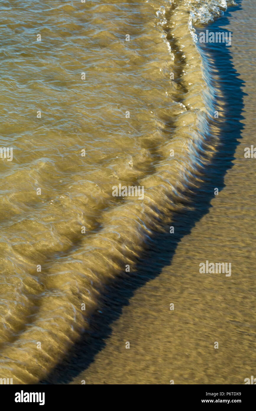 Pattern formed by water rushing back to the ocean as a wave recedes, on ...