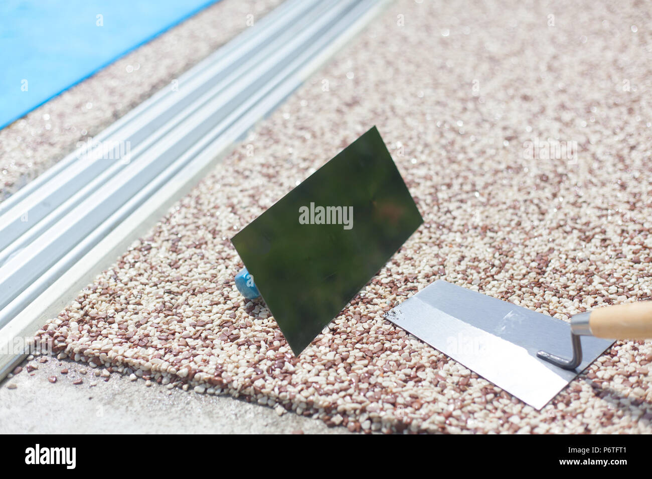 Coloured Concrete Around Pool with tools Stock Photo - Alamy