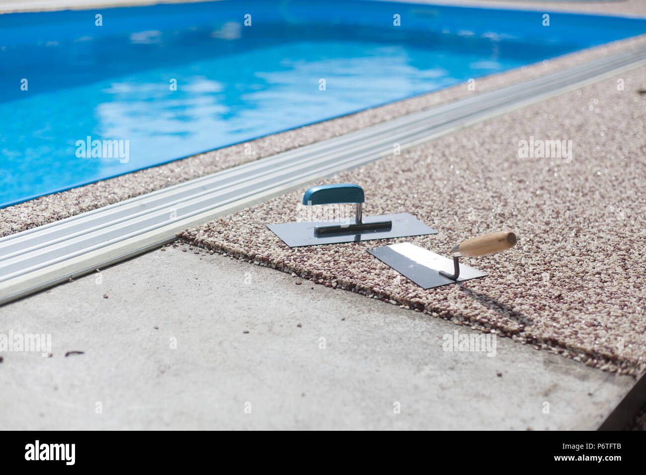 Coloured Concrete Around Pool with tools Stock Photo - Alamy