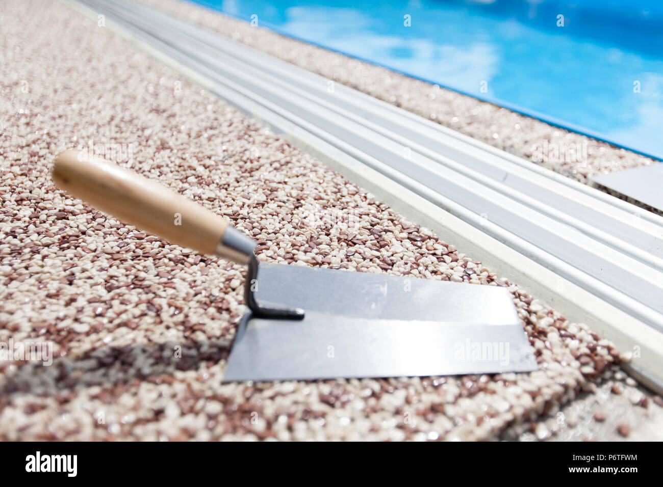 Coloured Concrete Around Pool with tools Stock Photo - Alamy