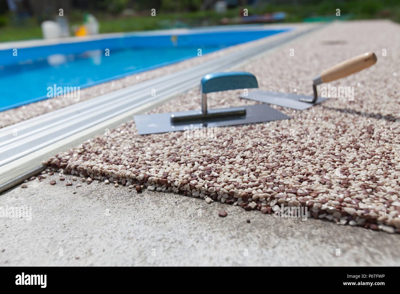 Coloured Concrete Around Pool with tools Stock Photo - Alamy