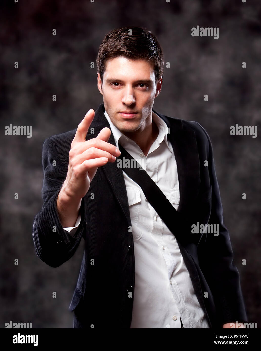 Angry Pointing Businessman isolated on dark background Stock Photo - Alamy