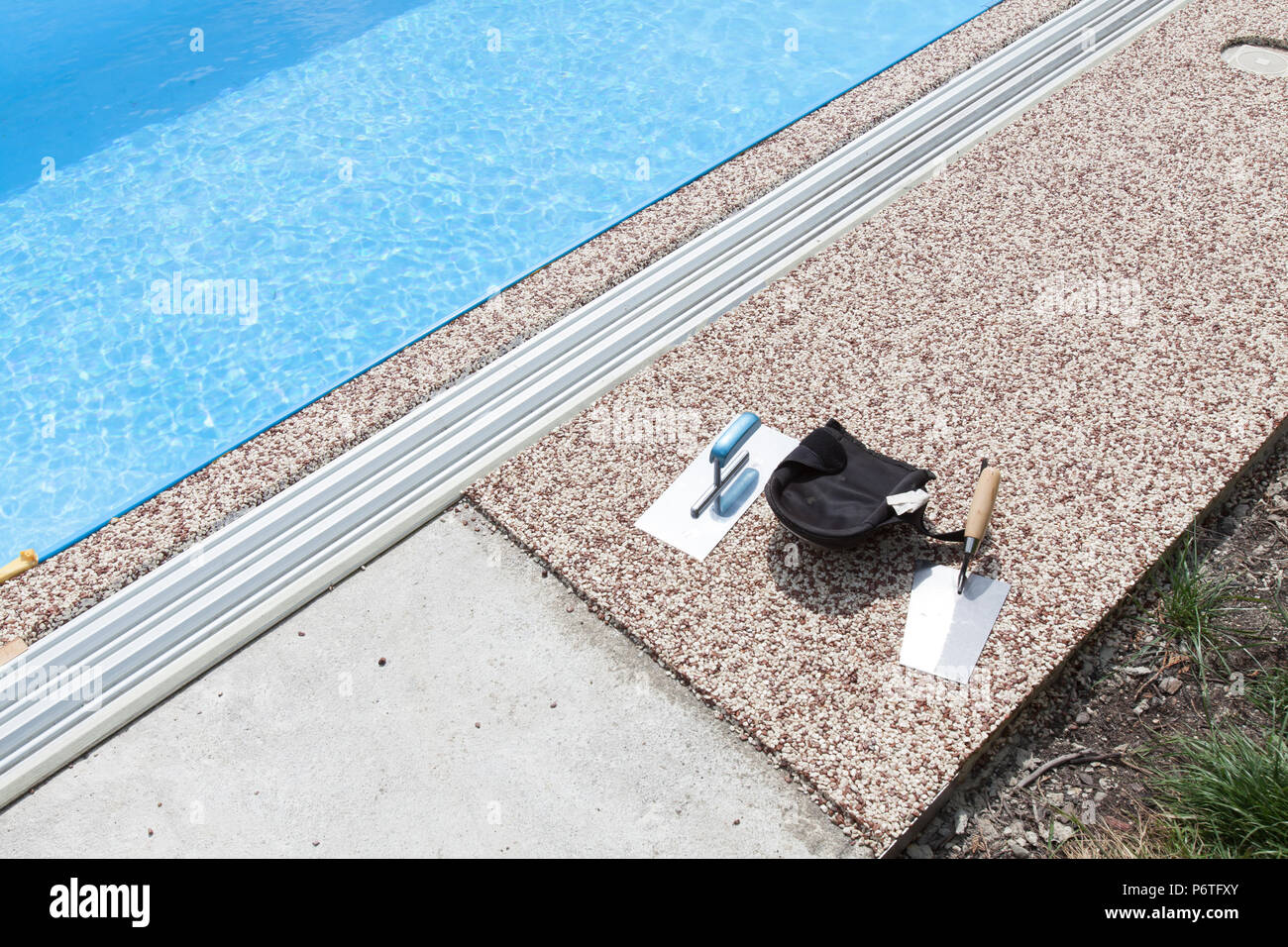 Coloured Concrete Around Pool with tools Stock Photo - Alamy